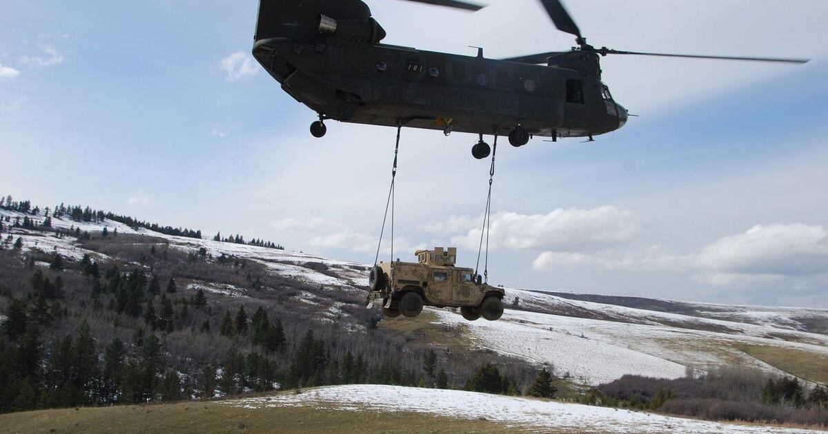 National Guard Chinook frees Air Force Humvee from muddy road