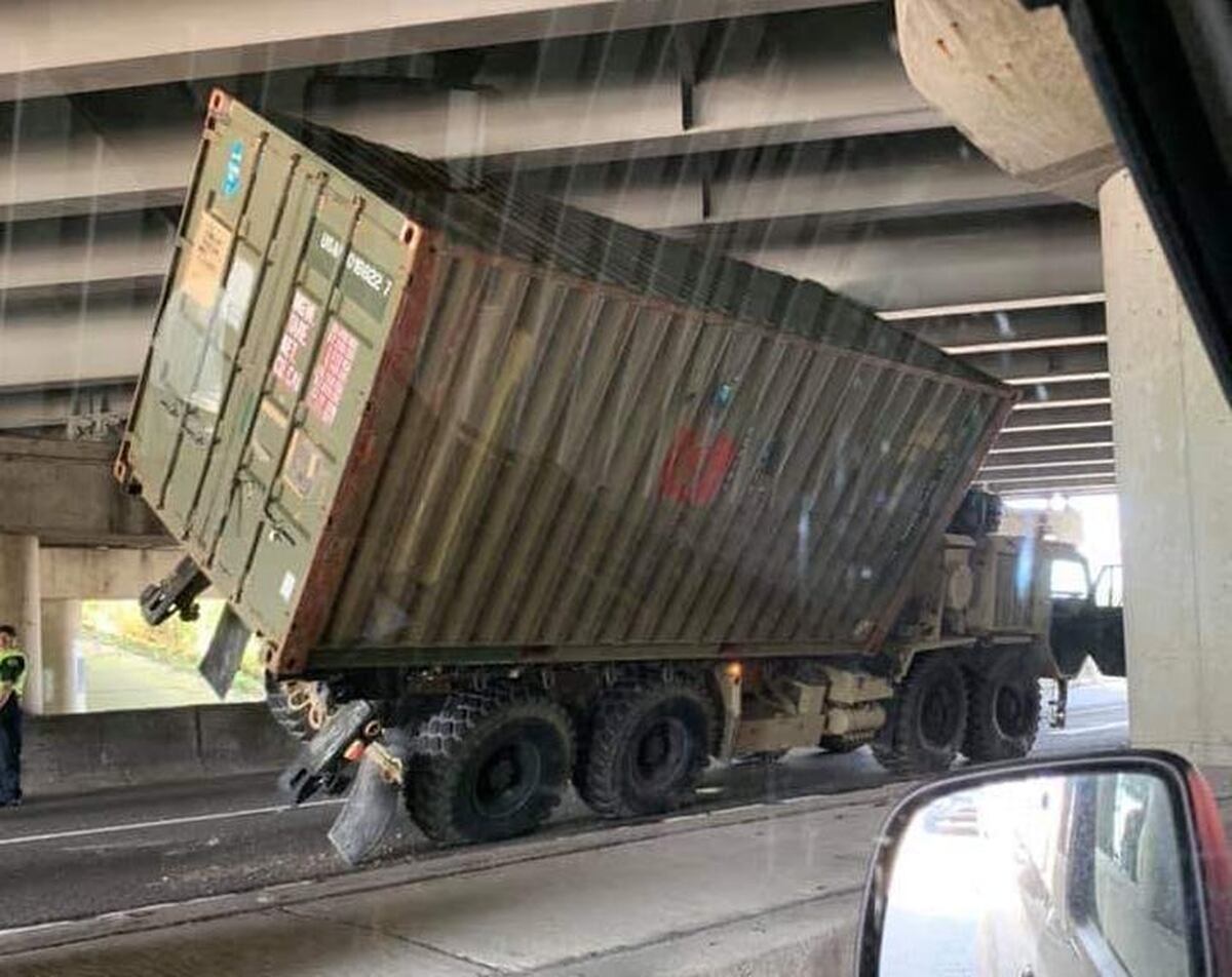 Convoy halted when vehicle gets stuck under overpass