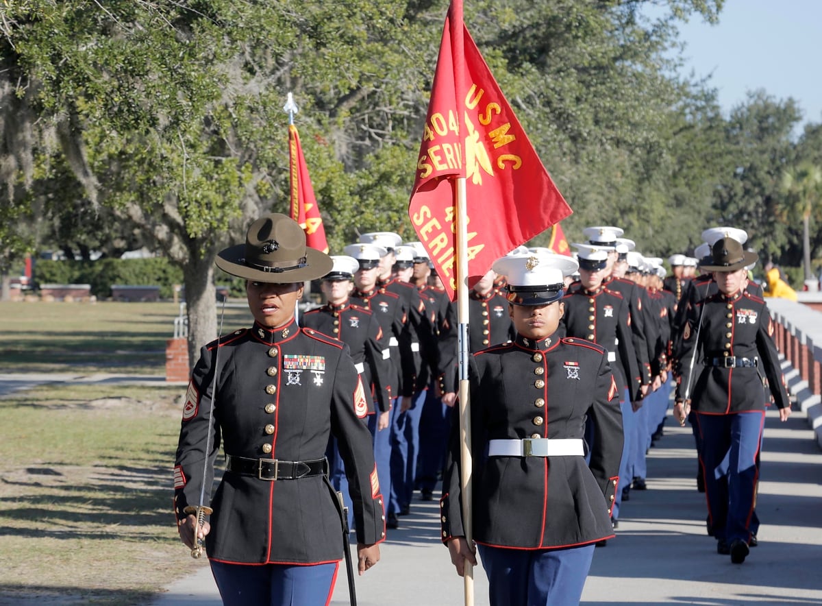 First company graduates in new dress blue uniform for female Marines