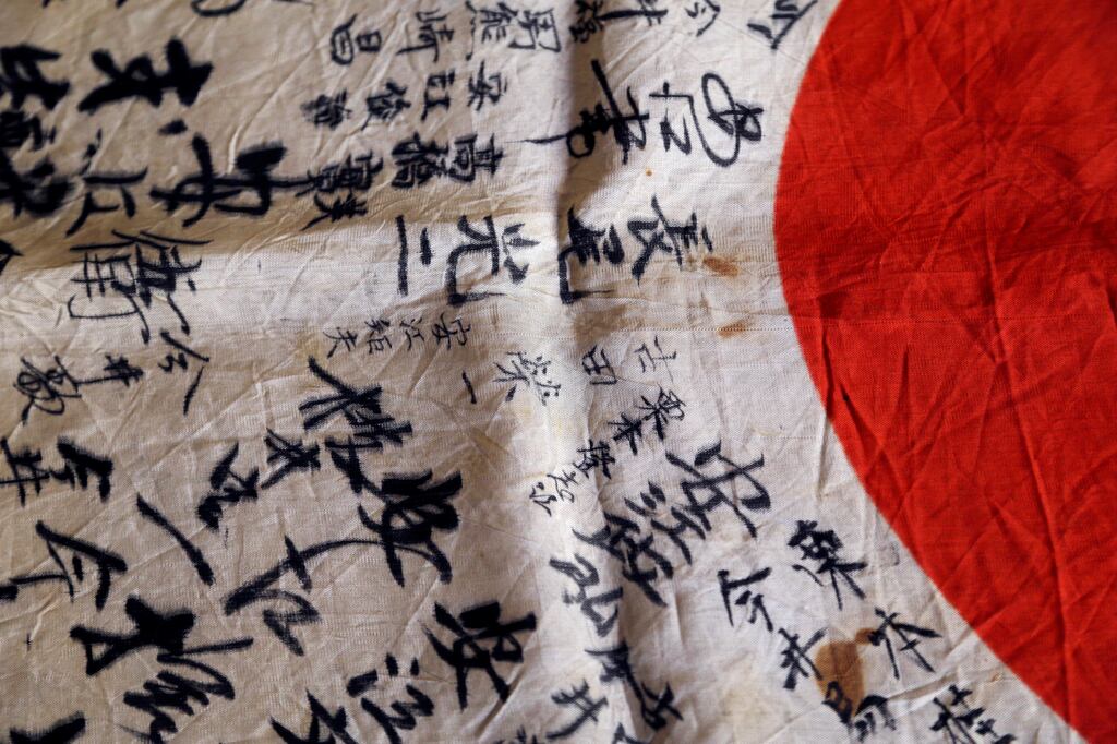 WWII veteran, 93, brings back flag taken from enemy soldier