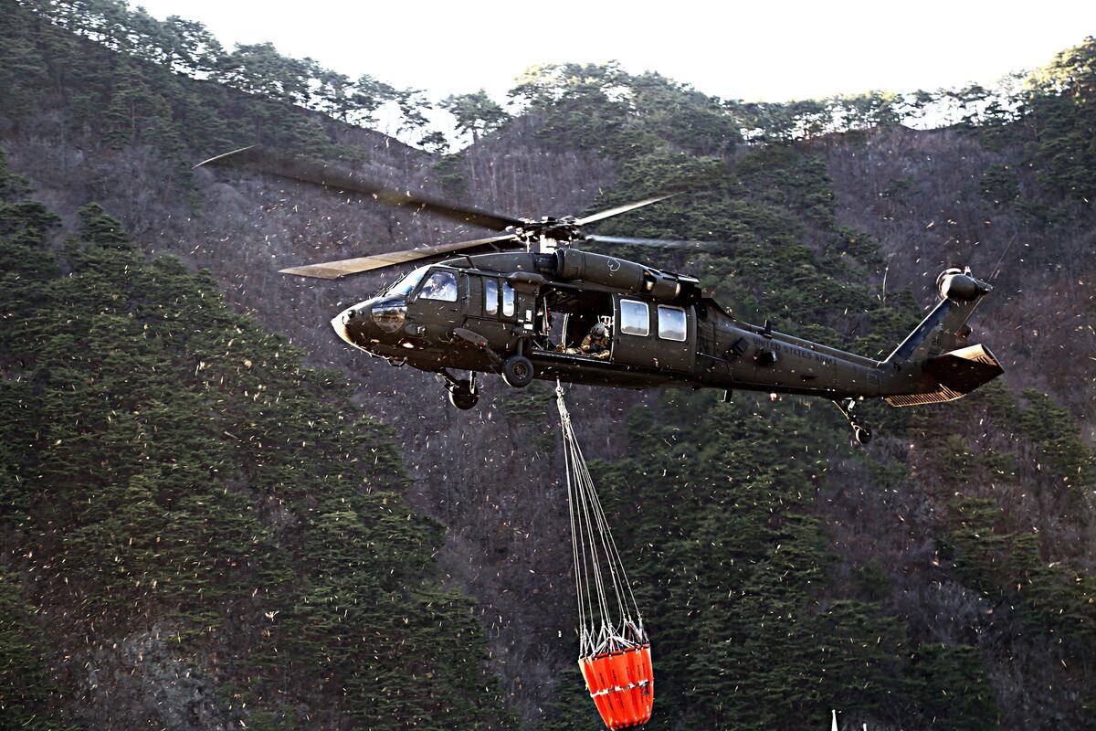 Army helicopter crews fight a wild fire in South Korea