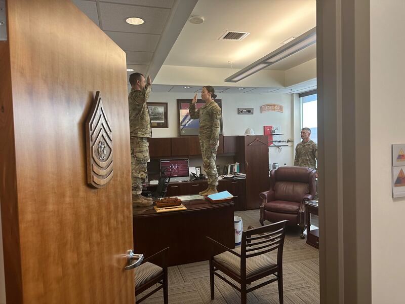 Soldier reenlists while standing on division sergeant major’s desk