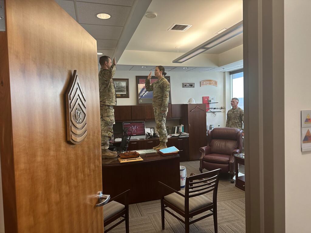 Soldier reenlists while standing on division sergeant major’s desk